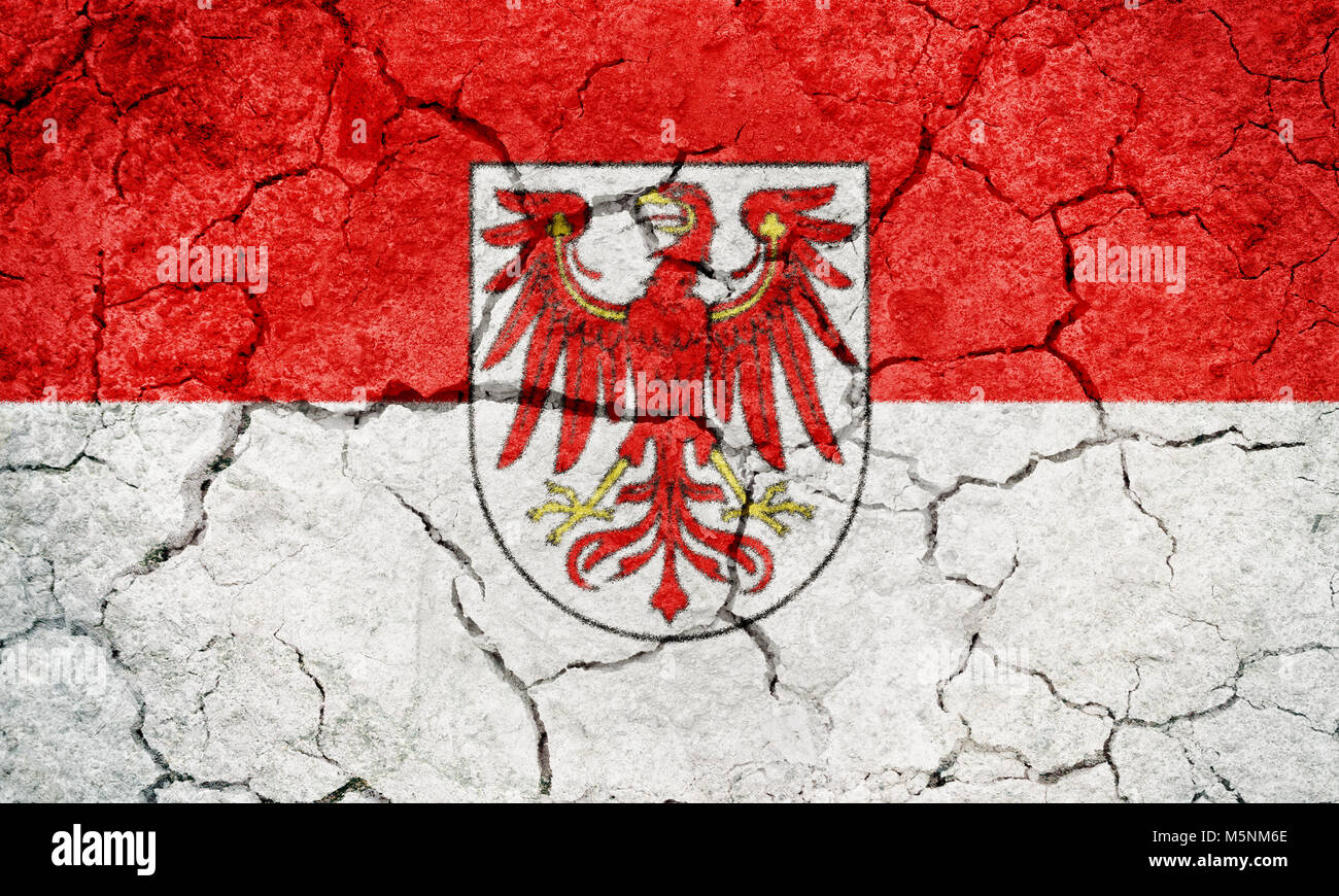 Brandenburg, state of Germany, flag on dry earth ground texture ...