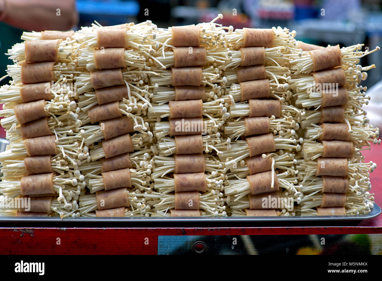 Japanese enoki mushroom wrapped in ham. Thailand food market Stock ...