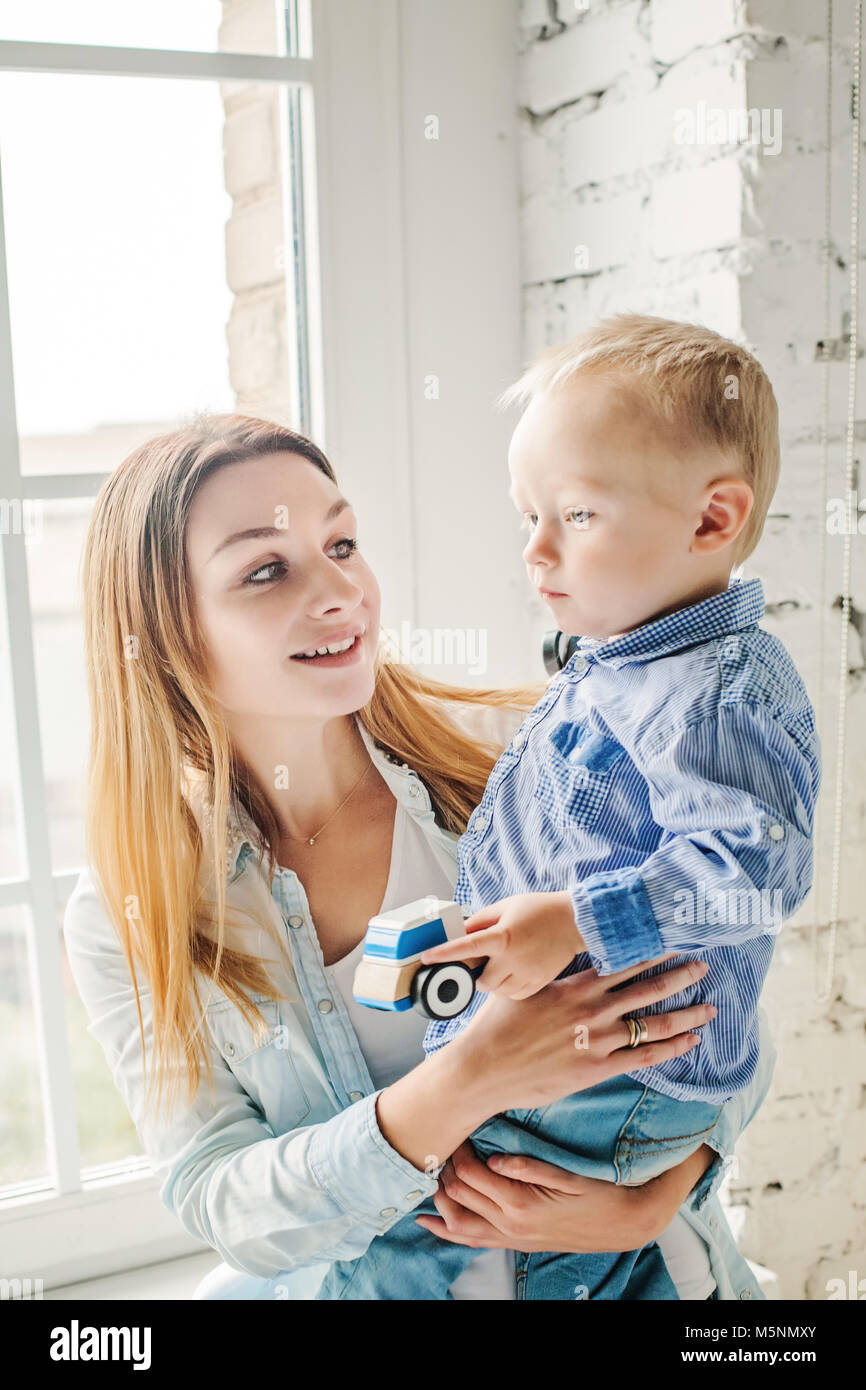 Happy Sun and her Mom Hugging at Home Lifestyle Portrait. Woman and ...