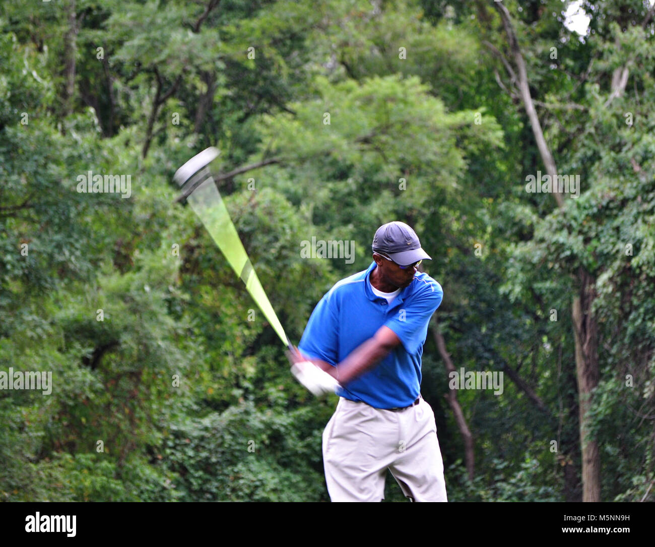 Male golfer teeing off with driver on a par 4 Stock Photo - Alamy