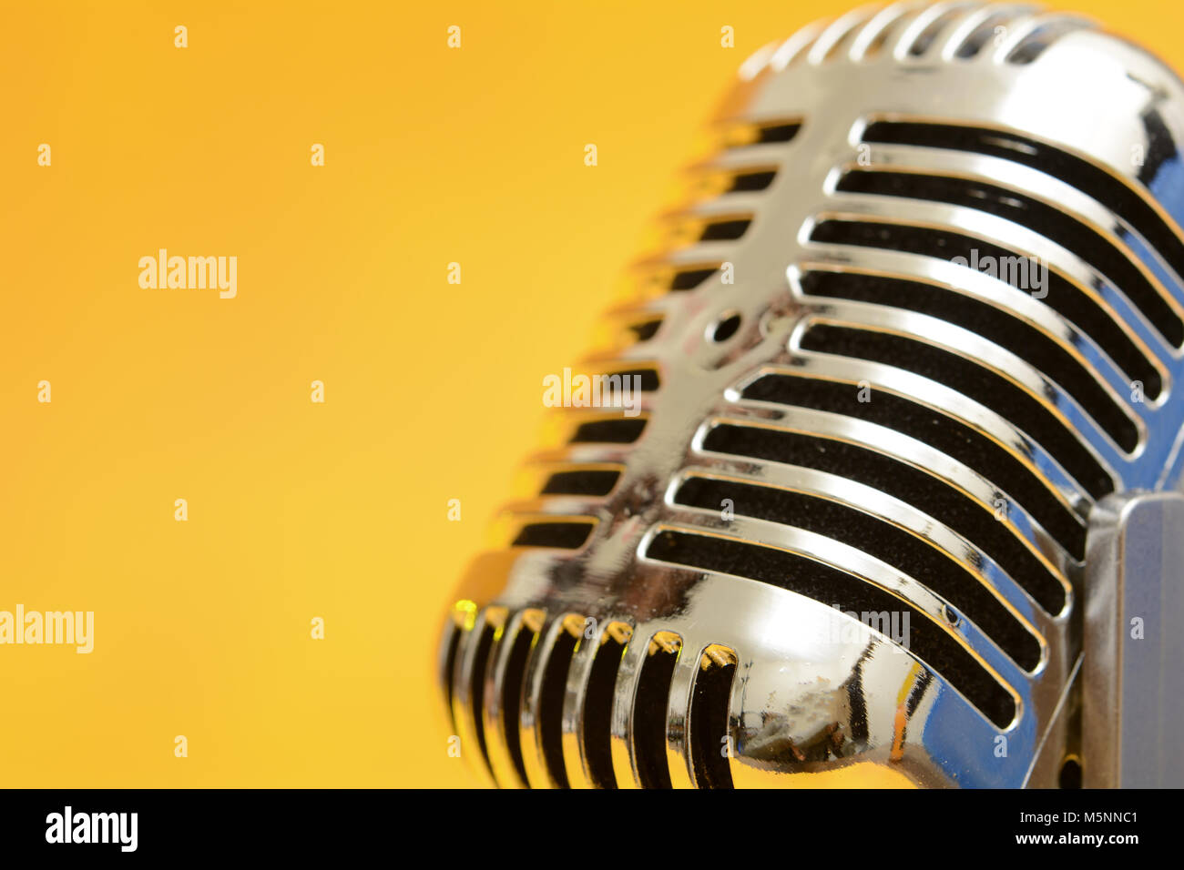 Closeup of vintage retro microphone on yellow background Stock Photo ...