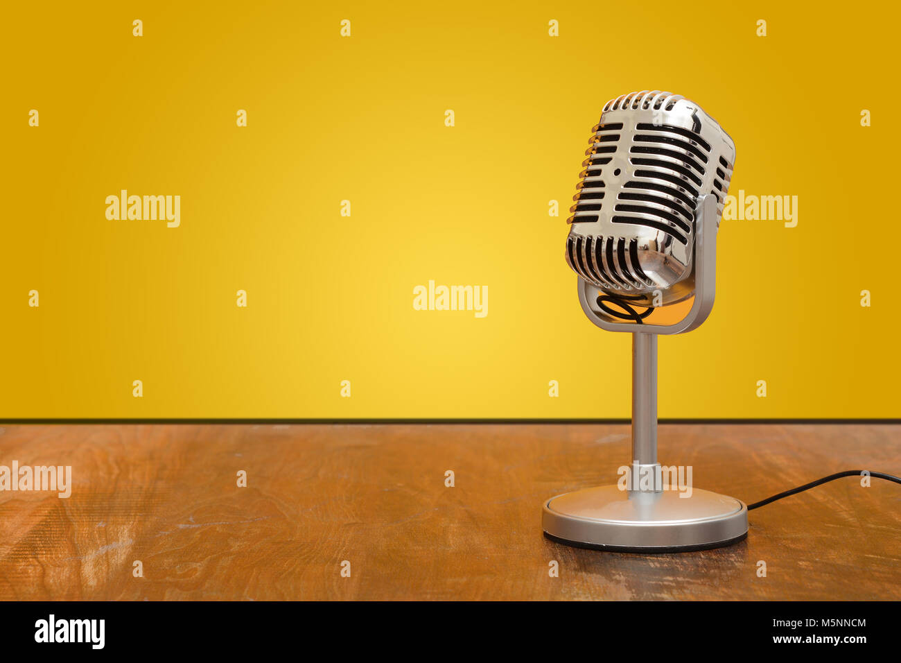 Retro style microphone recorder in studio with yellow background Stock ...