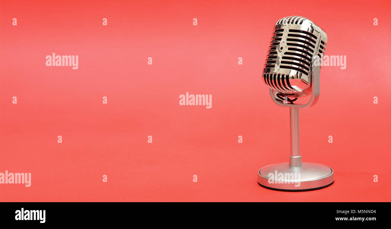 Retro vintage style metal microphone on red background banner Stock ...