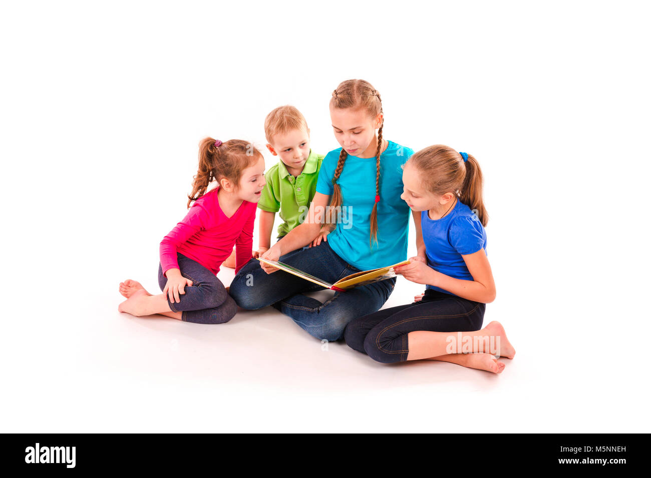 Happy kids reading a book isolated on white. Team work, creativity ...
