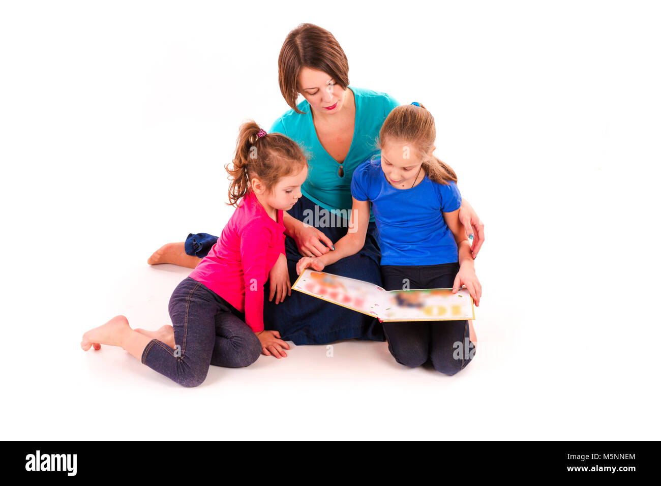 Mother reading a book to children isolated on white. Team work ...