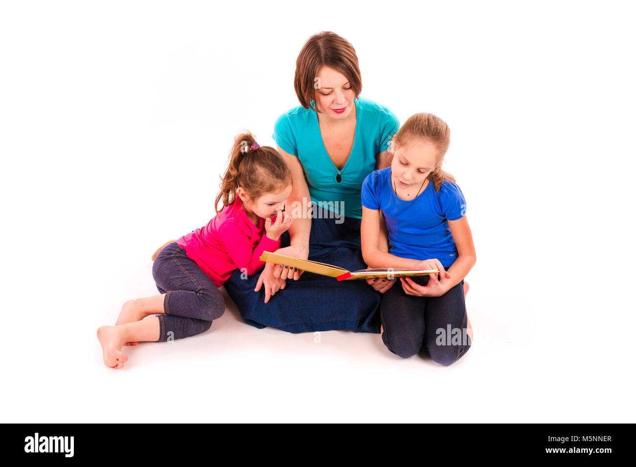 Mother reading a book to children isolated on white. Team work ...