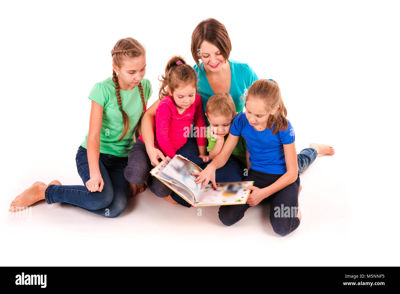 Mother reading a book to children isolated on white. Team work ...