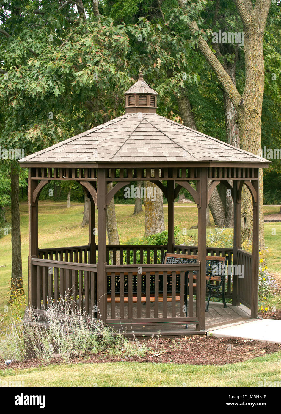 Wooden gazebo in park surrounded by trees Stock Photo - Alamy