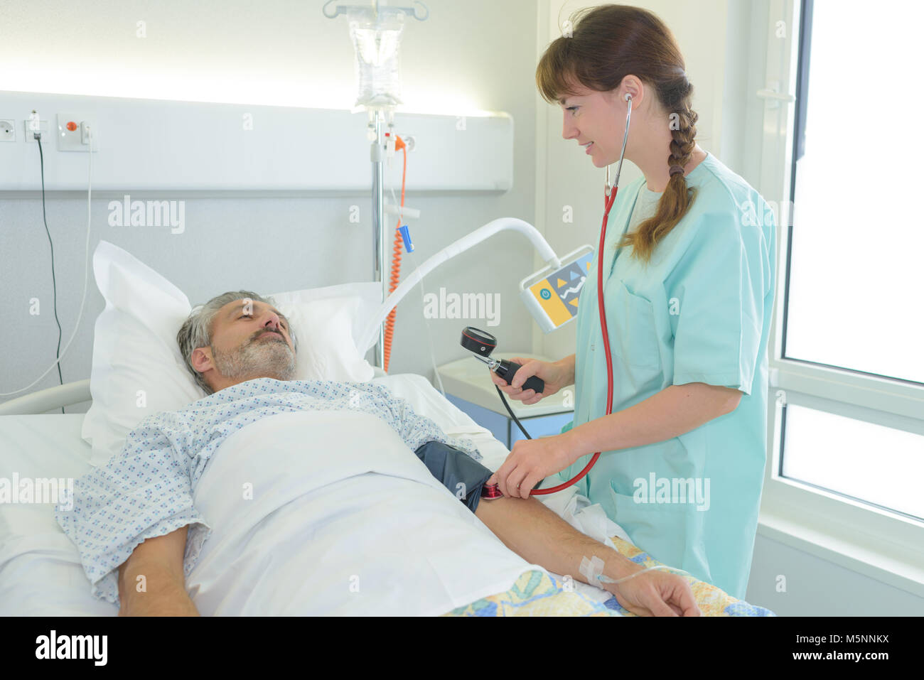 Nurse checking patient's blood pressure Stock Photo - Alamy