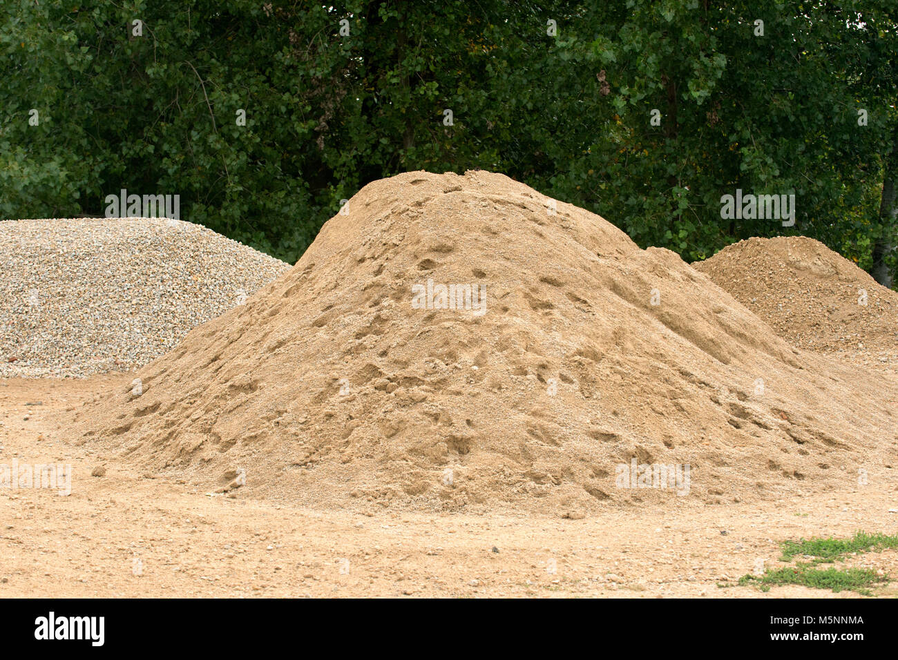 Piles of light yellow sand in a countryside area Stock Photo - Alamy