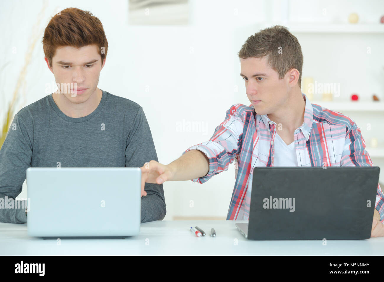 Two guys studying Stock Photo - Alamy
