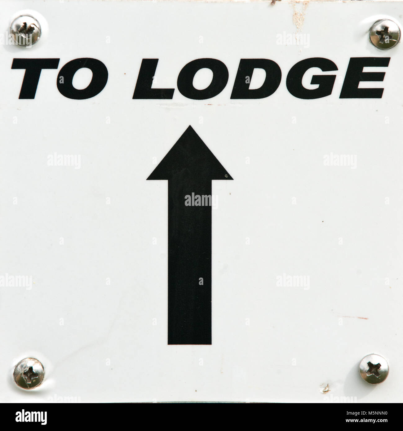 To lodge black direction arrow sign on white Stock Photo - Alamy