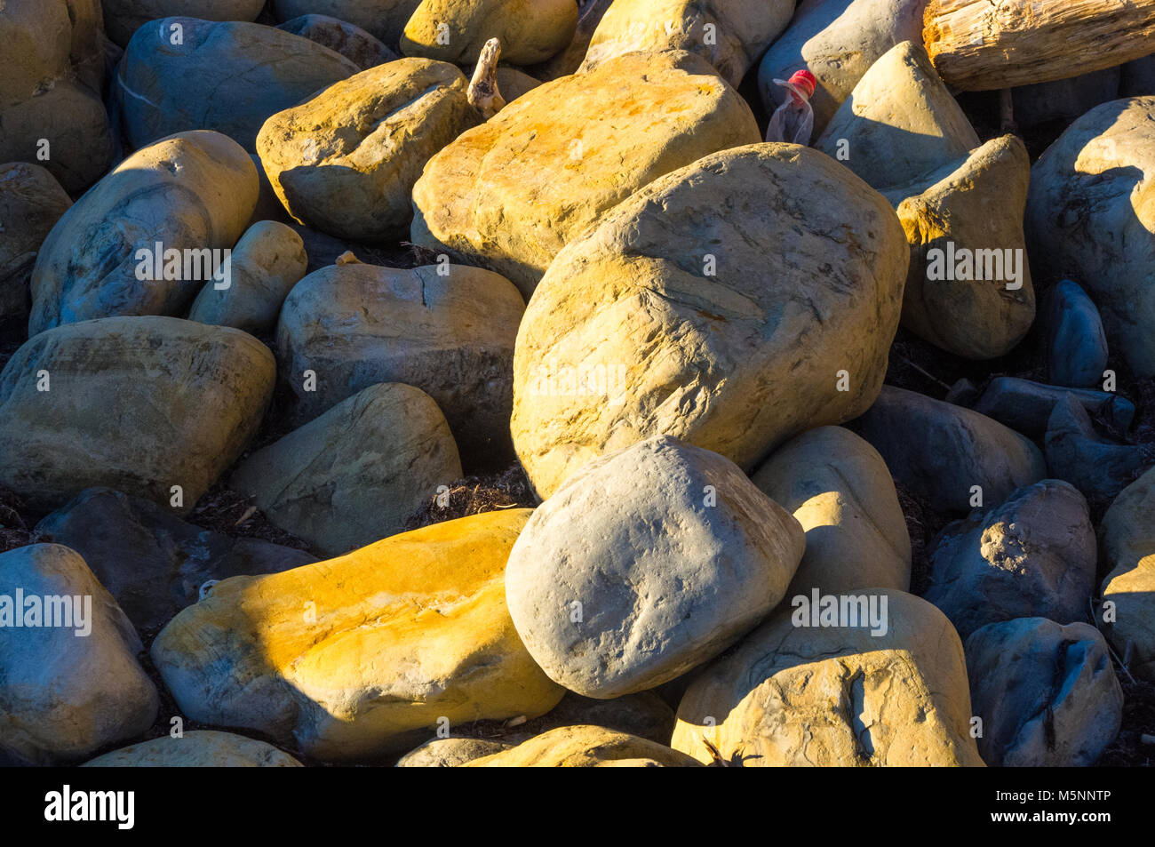 boulders and colorful pebbles on the beach on a warm summer day Stock ...