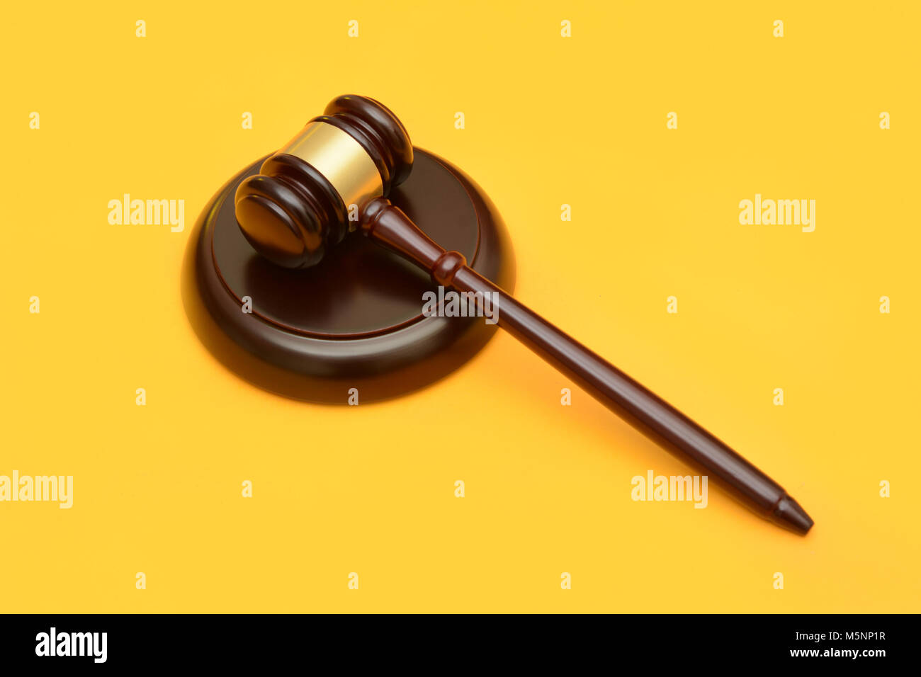 Wooden Judge Gavel on yellow background law concept Stock Photo - Alamy