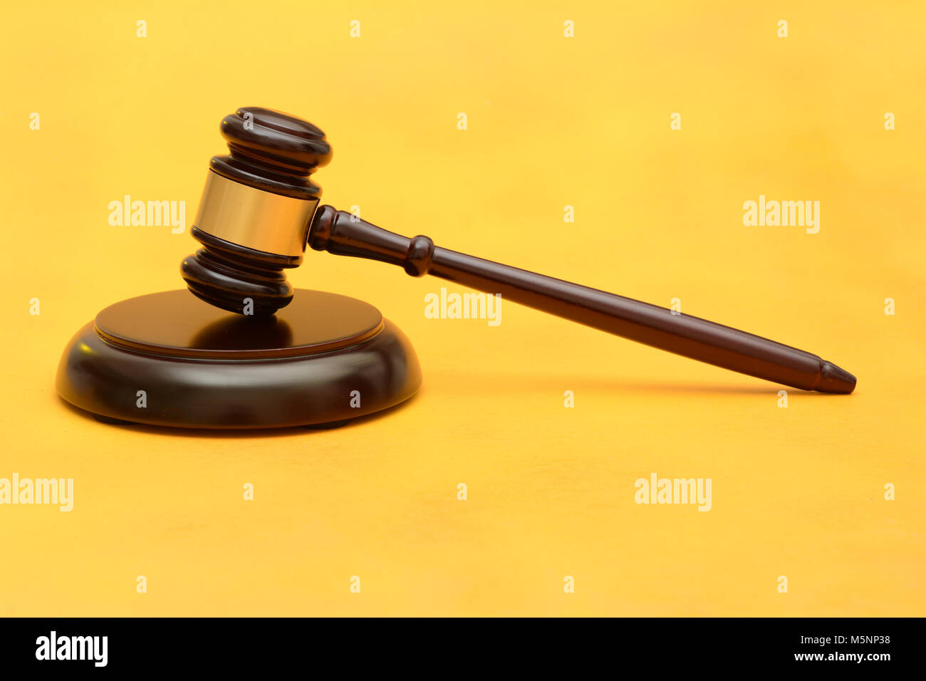 Wooden Judge Gavel on yellow background law concept Stock Photo - Alamy