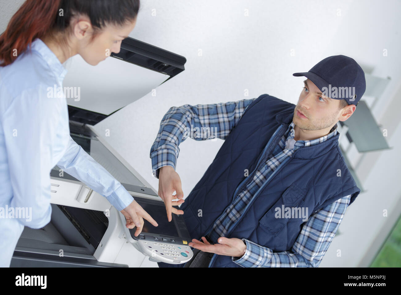 People talking by printer hi-res stock photography and images - Alamy