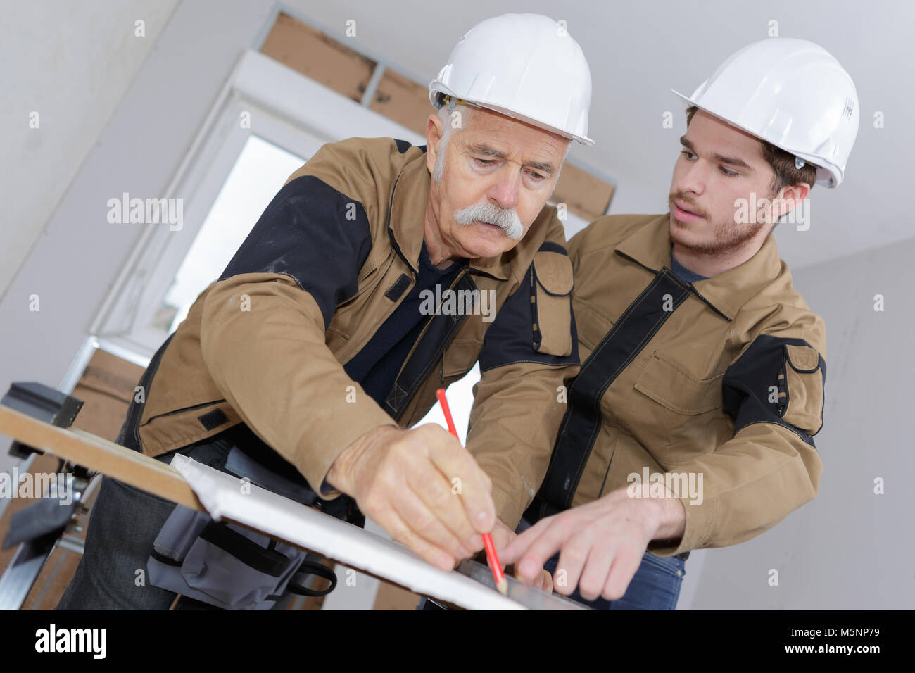 senior craftsman drawing a plan at carpenter workshop Stock Photo - Alamy
