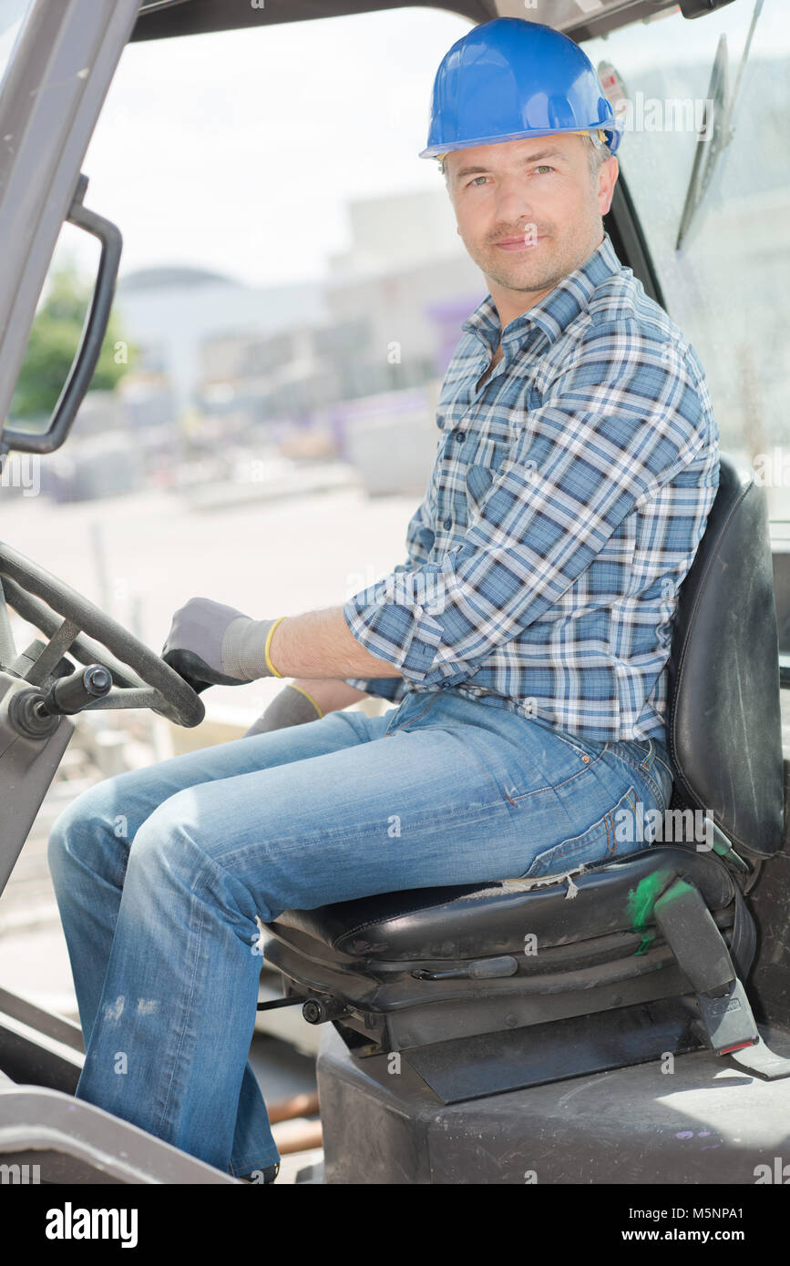 industrial worker driving a vehicle Stock Photo - Alamy