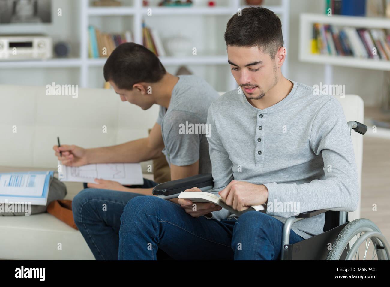 two male students going over their homework Stock Photo - Alamy