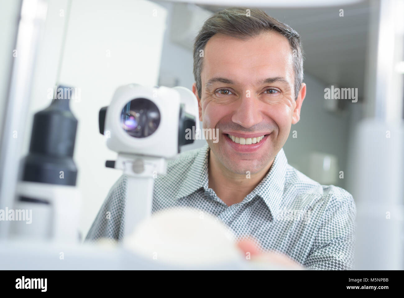 portrait of handsome happy optician Stock Photo - Alamy