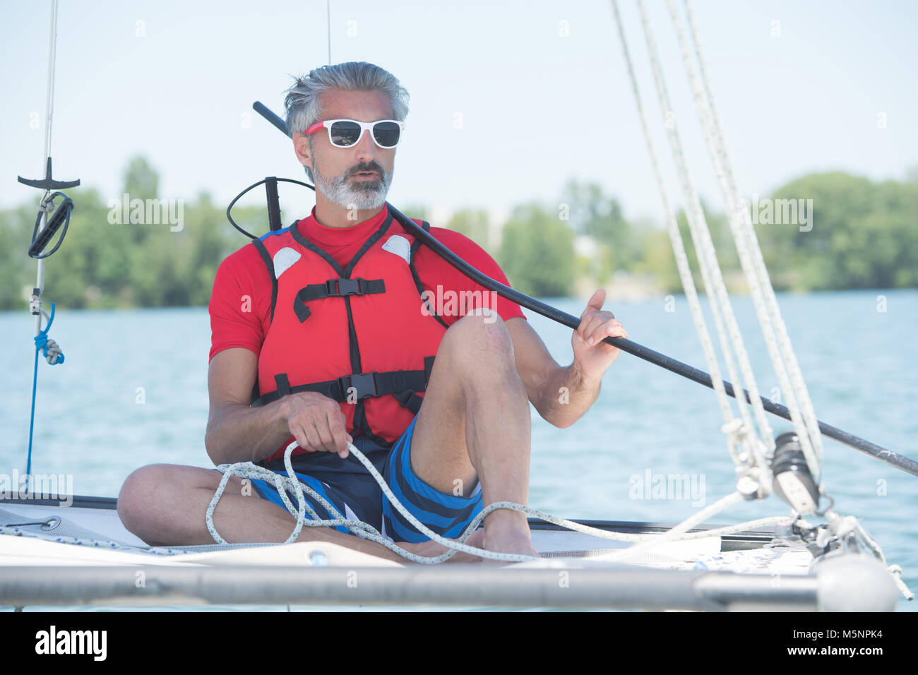 man sailing with sails out on a sunny day Stock Photo - Alamy