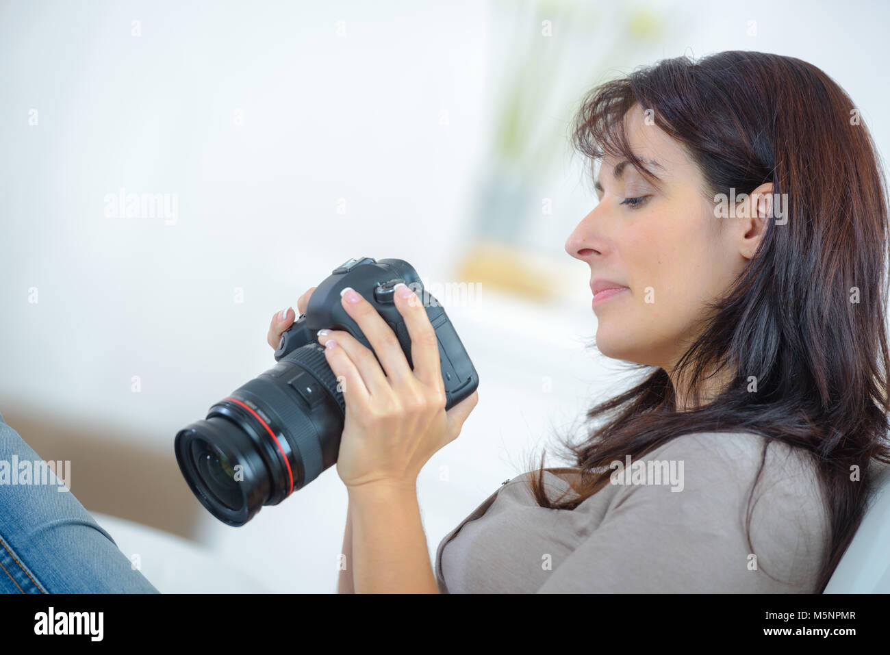 female photographer checking picture in camera Stock Photo - Alamy
