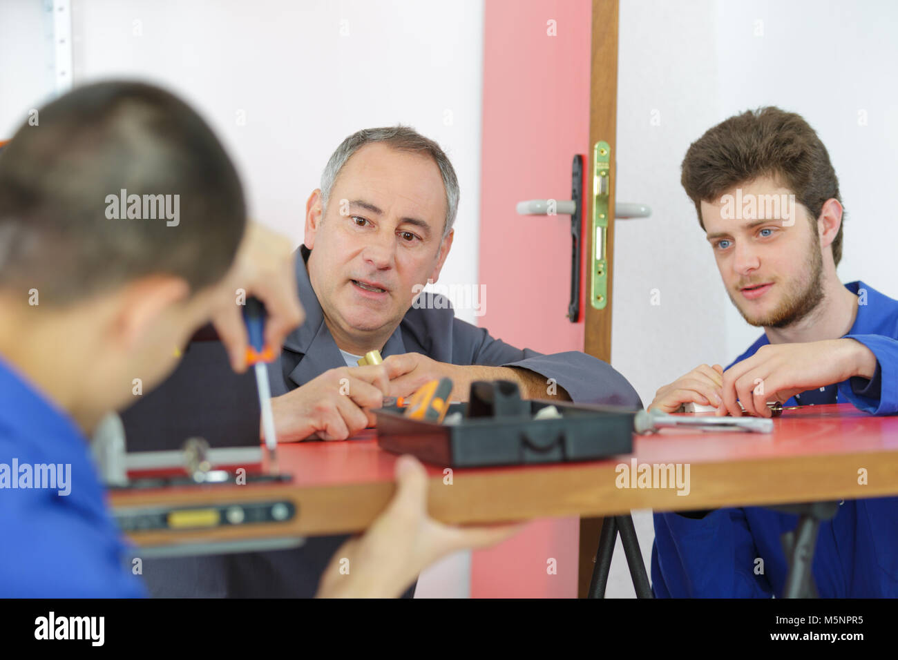 men building a door Stock Photo - Alamy