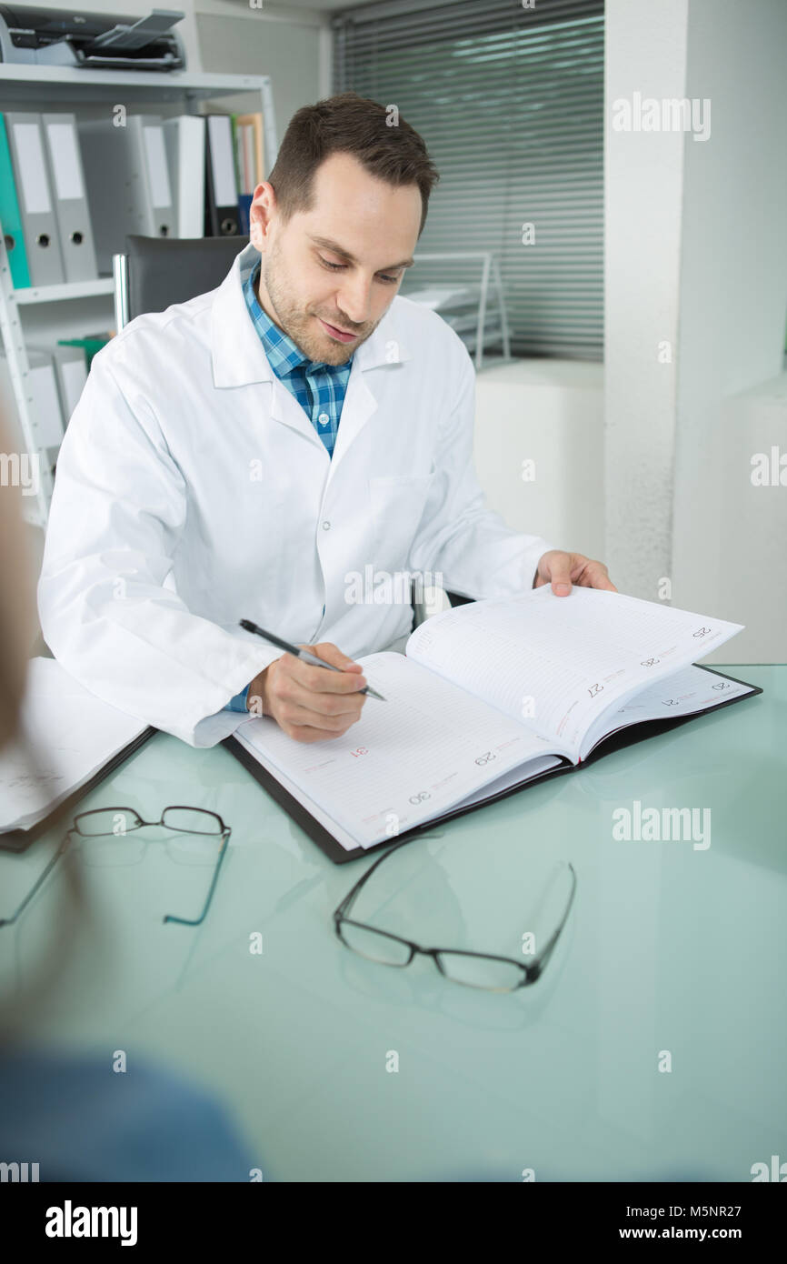 doctor writing on schedule Stock Photo - Alamy