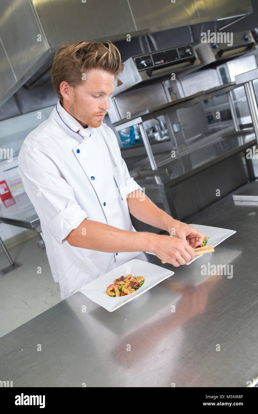 male chef presenting food on the plate Stock Photo - Alamy