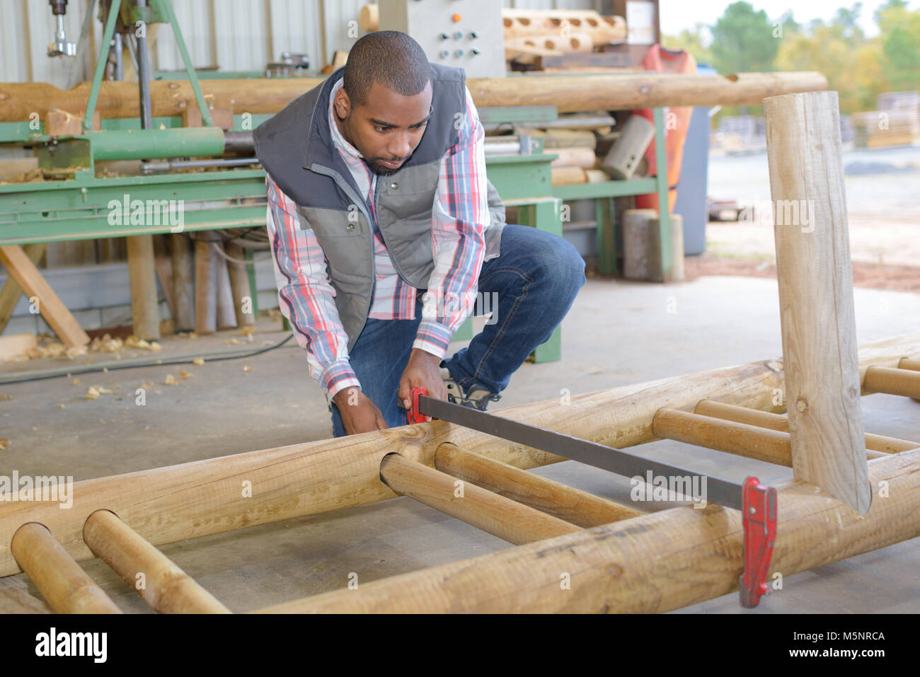 Man clamping wood together Stock Photo - Alamy