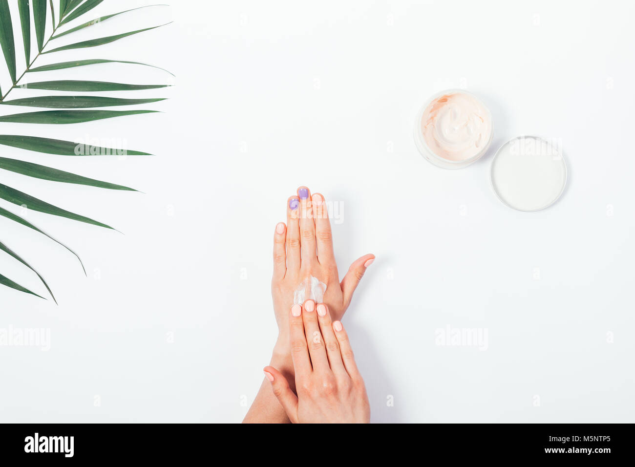 Woman applying cream on hands on white background top view Stock Photo ...