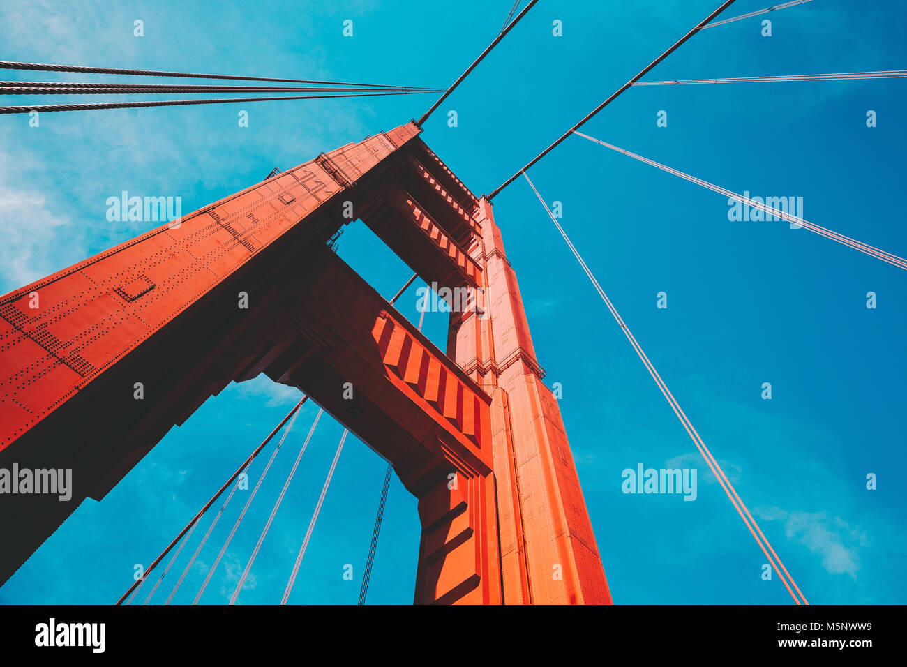Beautiful low angle view of famous Golden Gate Bridge with blue sky and ...