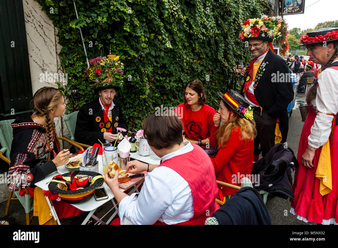 A Group Of Young Morris Dancers Eating Lunch At A Cafe During The ...