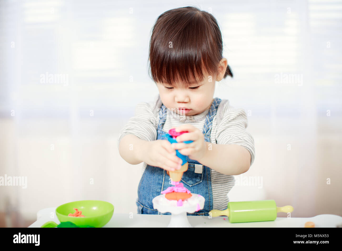 baby girl pretend play food toy Stock Photo - Alamy