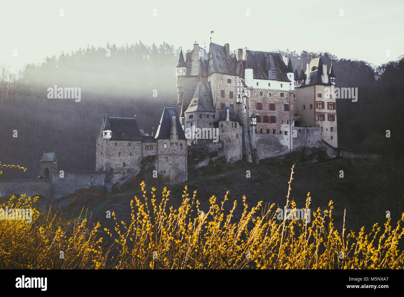 Beautiful view of famous Eltz Castle in scenic golden morning light at ...