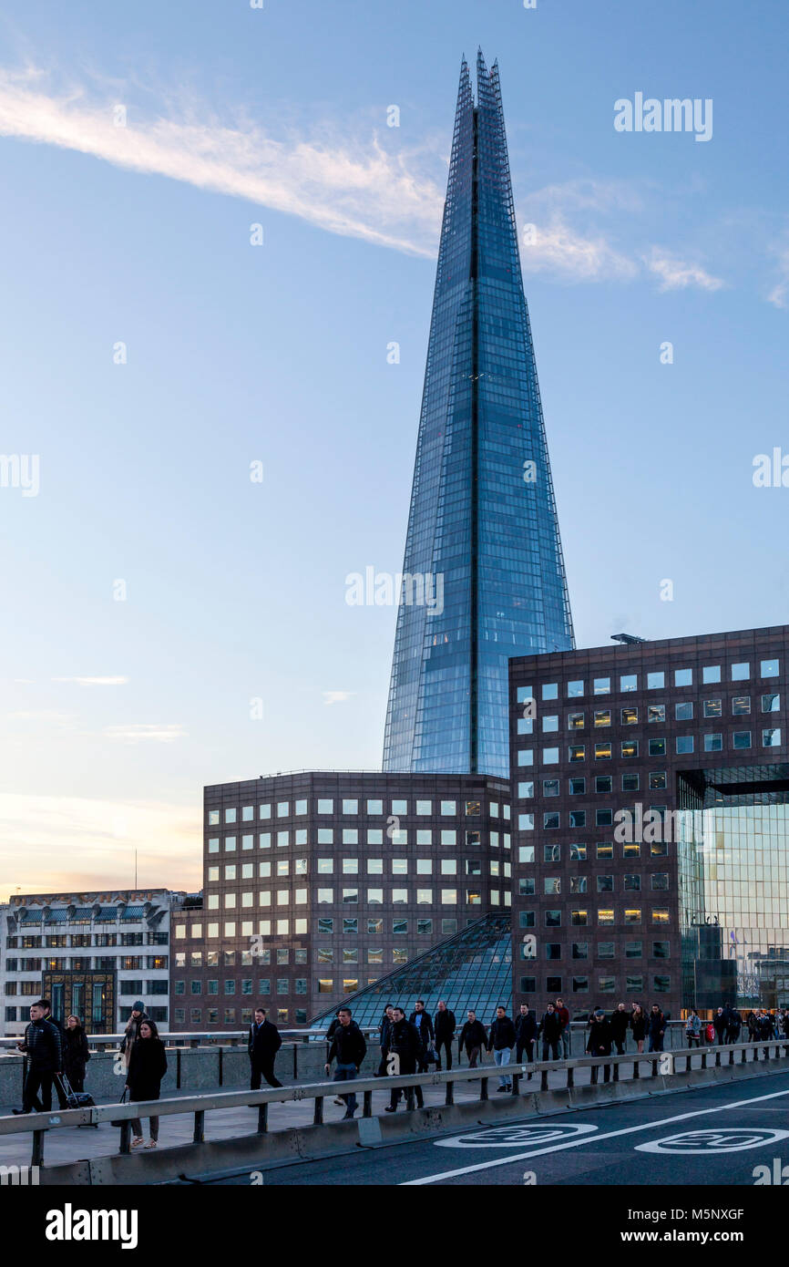 Commuters Walking Across London Bridge On Their Way To Work In The City ...