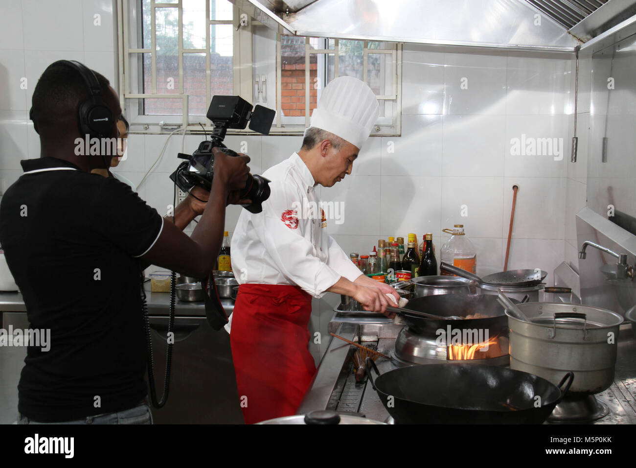 Kigali, Rwanda. 24th Feb, 2018. Chef Tao Yukun cooks dishes of Chinese ...
