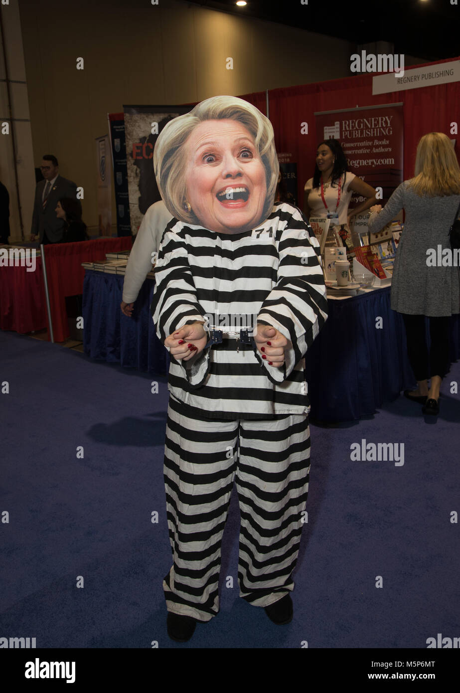 A women dressed as Hillary Clinton in a striped prison uniform wearing ...