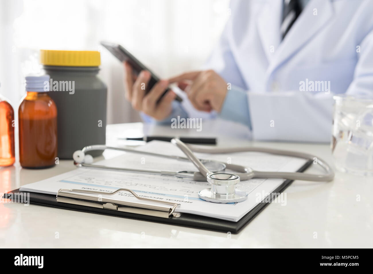 stethoscope and document on desk's doctor by doctor working in ...