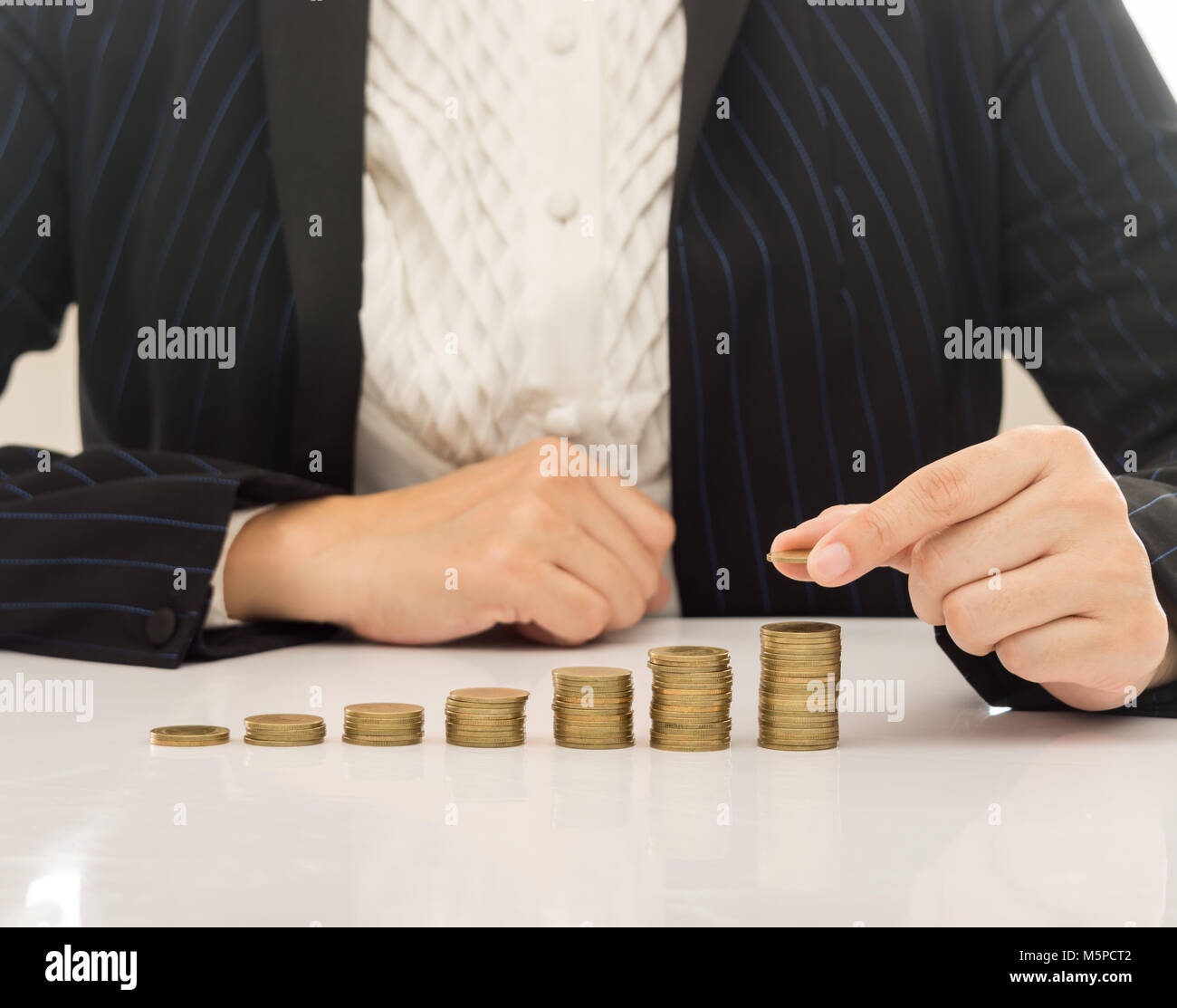 business person hand put coins to stack of coins. growth in business ...