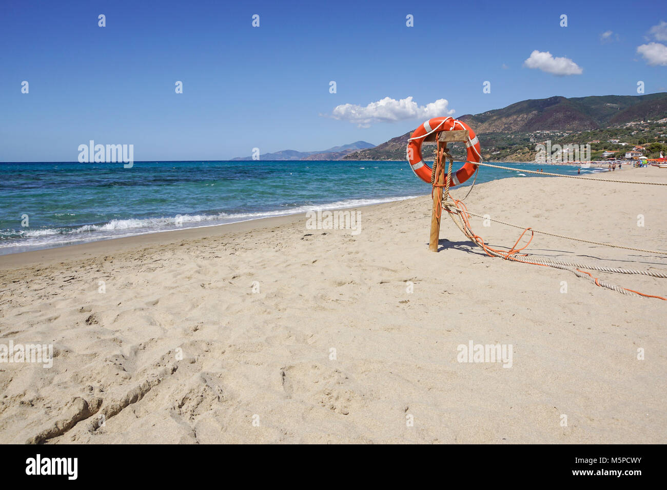 Life preserver on sandy beach somewhere near at sea Stock Photo - Alamy