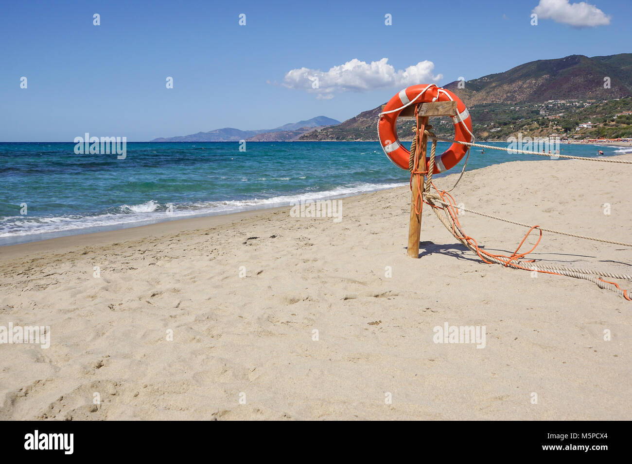 Life preserver on sandy beach somewhere near at sea Stock Photo - Alamy