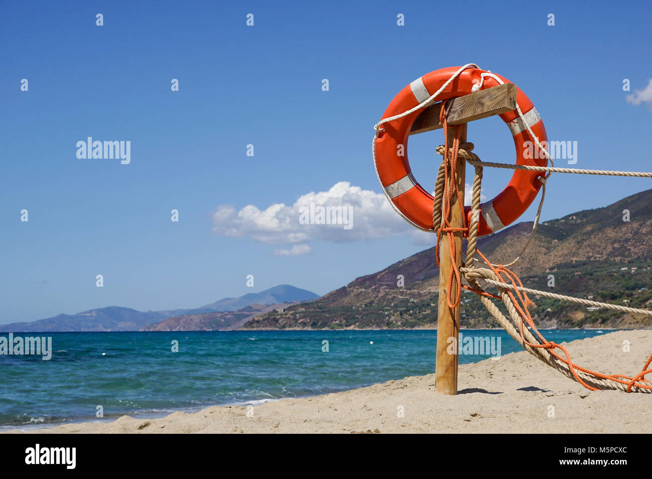 Life preserver on sandy beach somewhere near at sea Stock Photo - Alamy