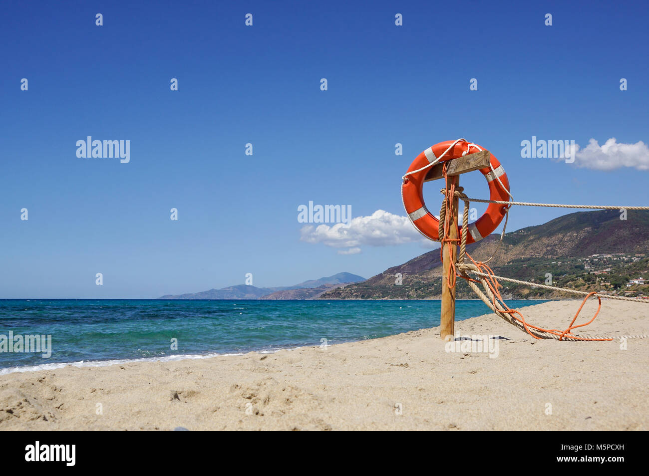 Life preserver on sandy beach somewhere near at sea Stock Photo - Alamy