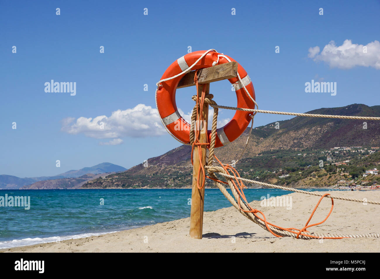 Life preserver on sandy beach somewhere near at sea Stock Photo - Alamy