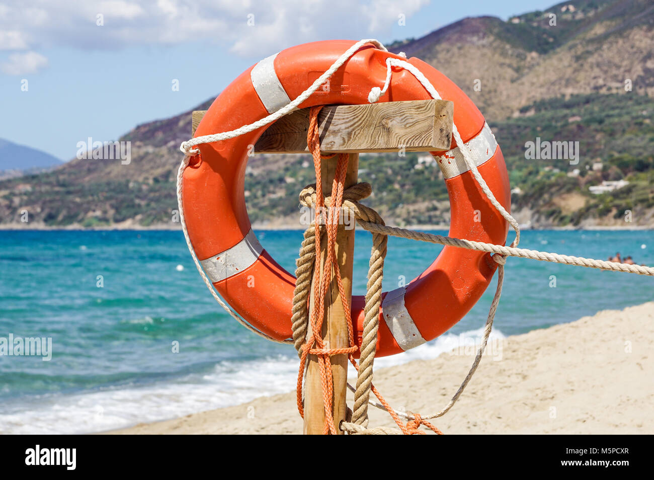 Life preserver on sandy beach somewhere near at sea Stock Photo - Alamy
