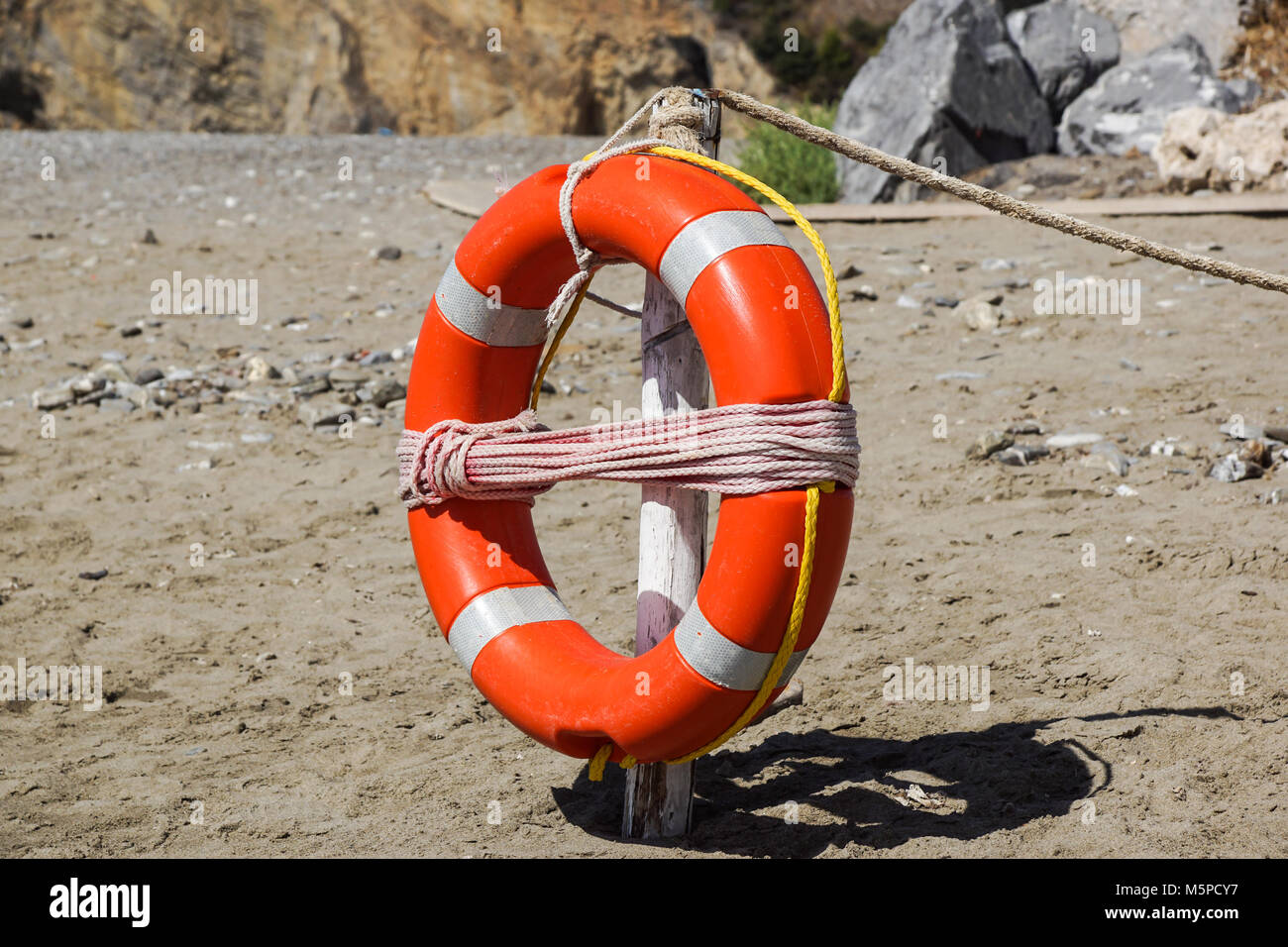 Life preserver on sandy beach somewhere near at sea Stock Photo - Alamy