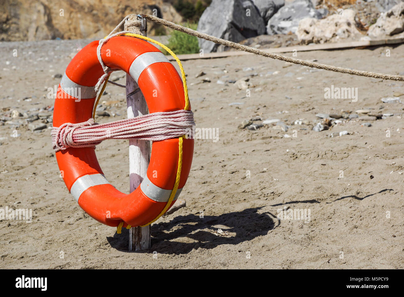 Life preserver on sandy beach somewhere near at sea Stock Photo - Alamy