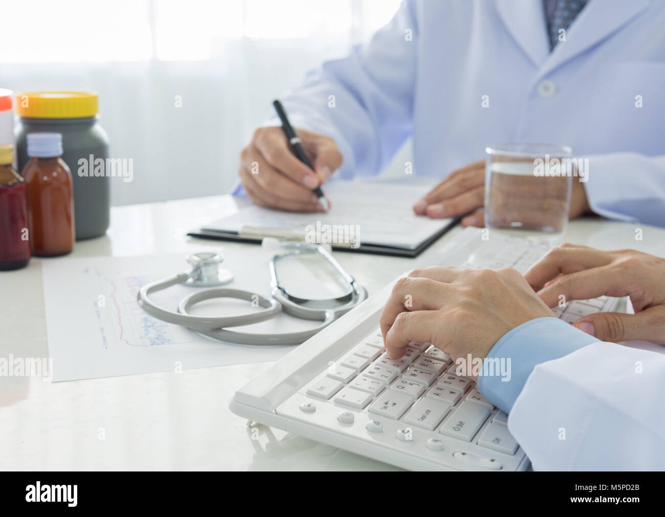 2 doctors working in office of hospital Stock Photo - Alamy