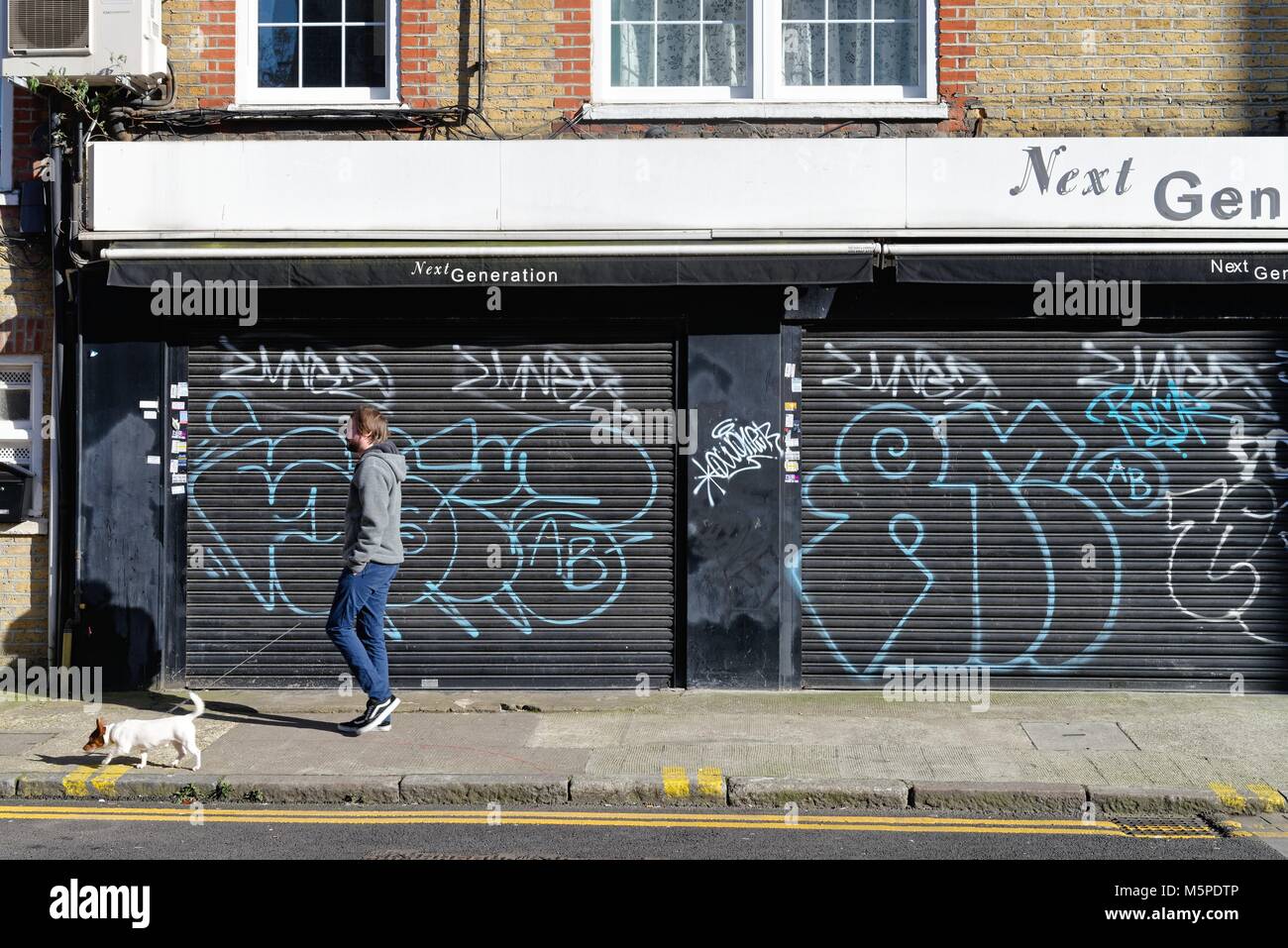 Shuttered shops with graffiti in Toynbee street Whitechapel London ...